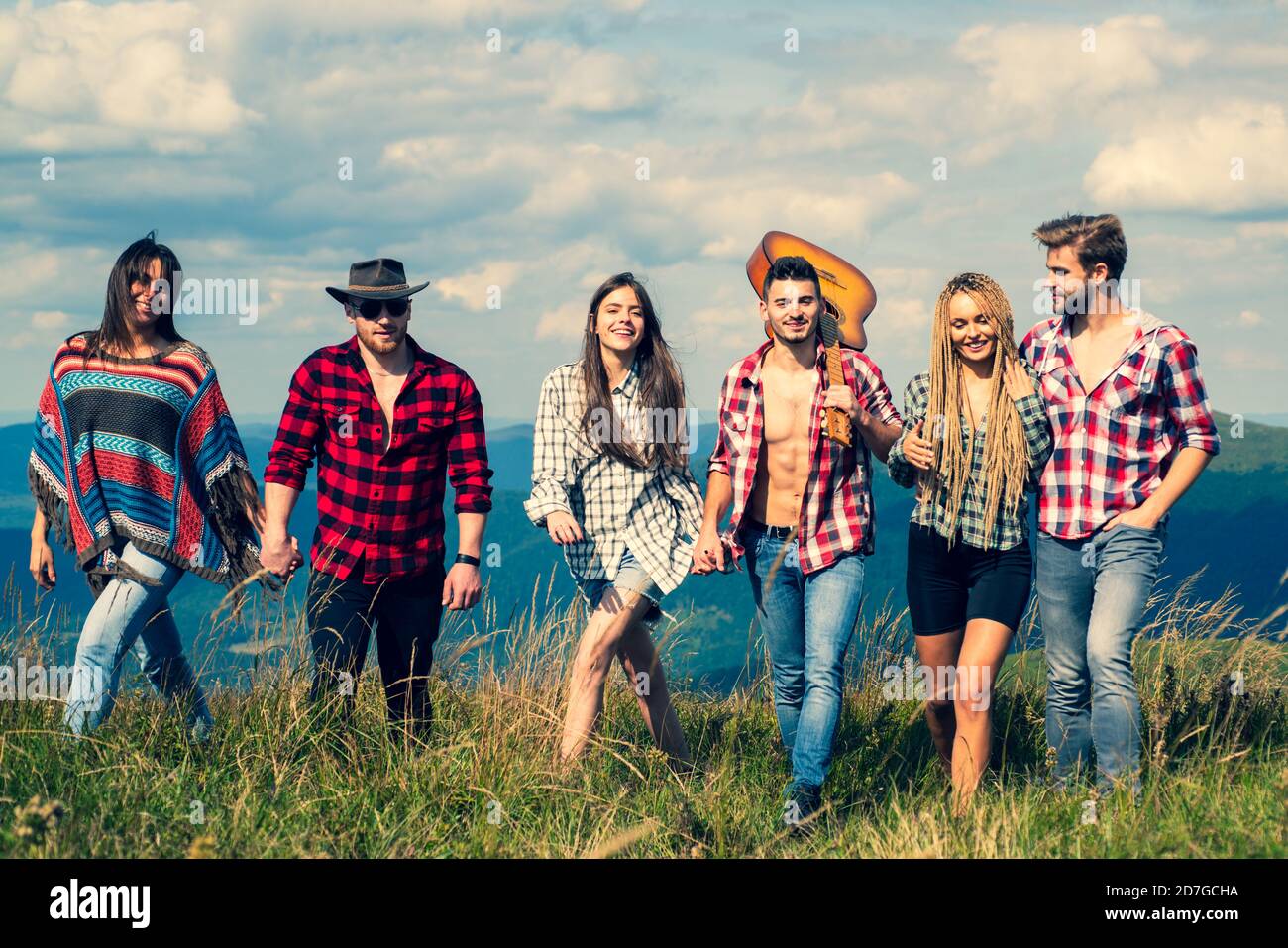 Happy friends walking on nature. Group of people having fun outdoors ...