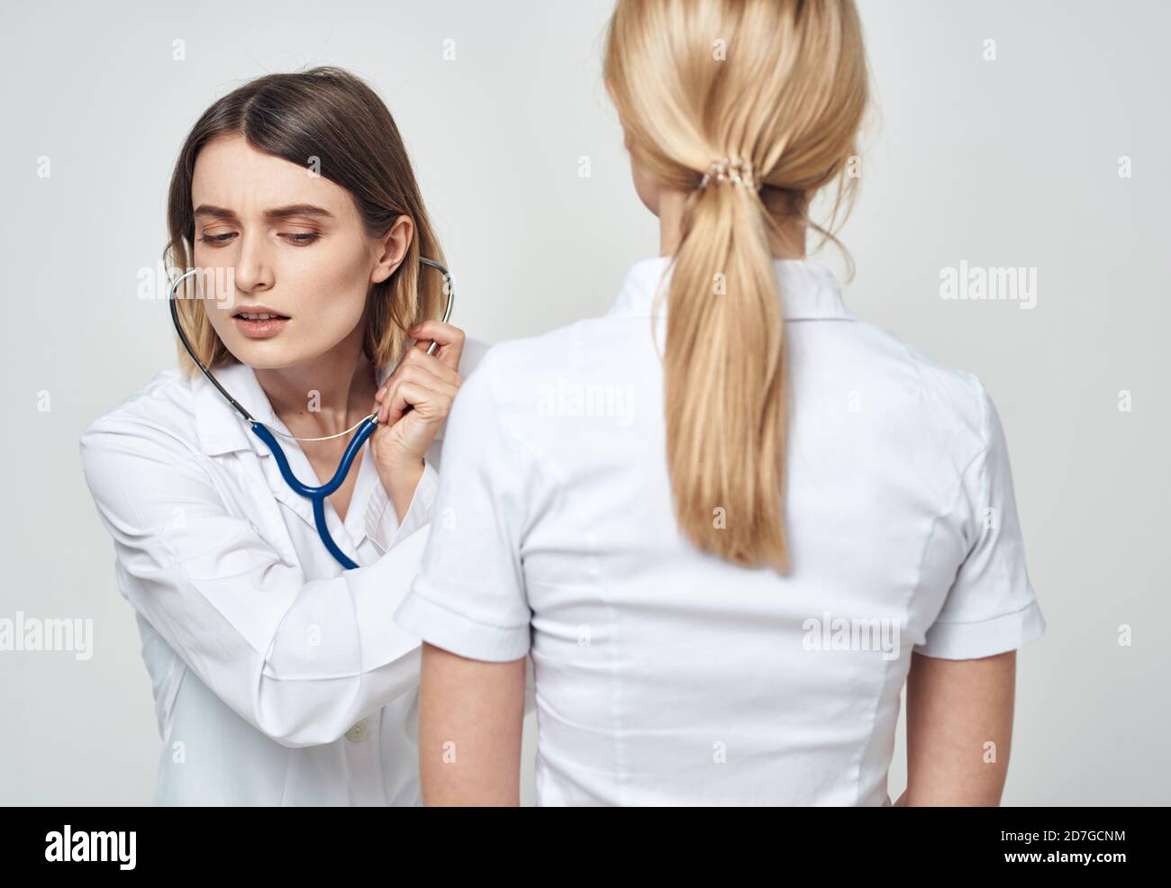 nurse in medical gown stethoscope and patient back view Stock Photo - Alamy