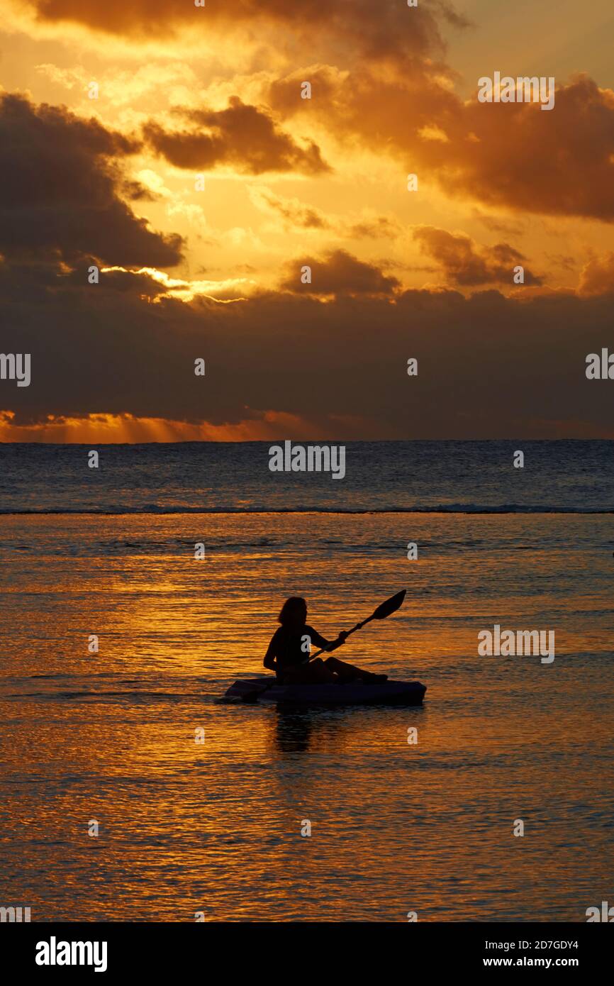 Kayaker at sunset, Rarotonga, Cook Islands, South Pacific (model ...