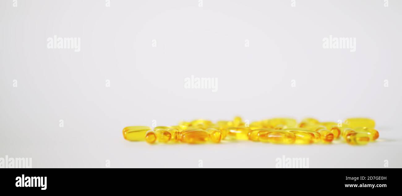 Medical medicines and supplements transparent capsules of yellow color ...