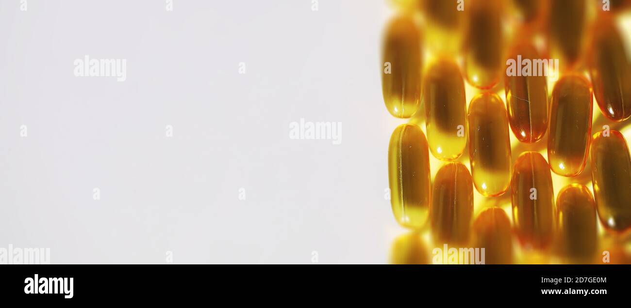 Medical medicines and supplements transparent capsules of yellow color ...