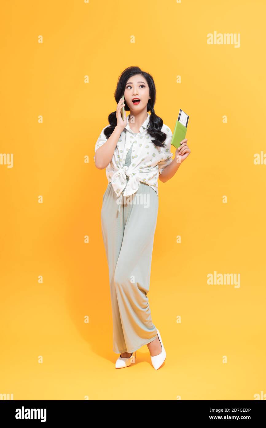 Image of successful voyage girl 20s expressing delight while holding ...