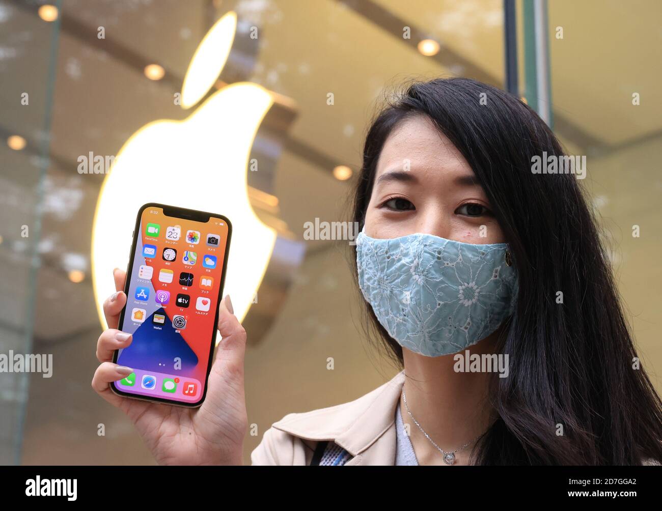 Tokyo, Japan. 23rd Oct, 2020. A customer displays her iPhone 12 as she ...