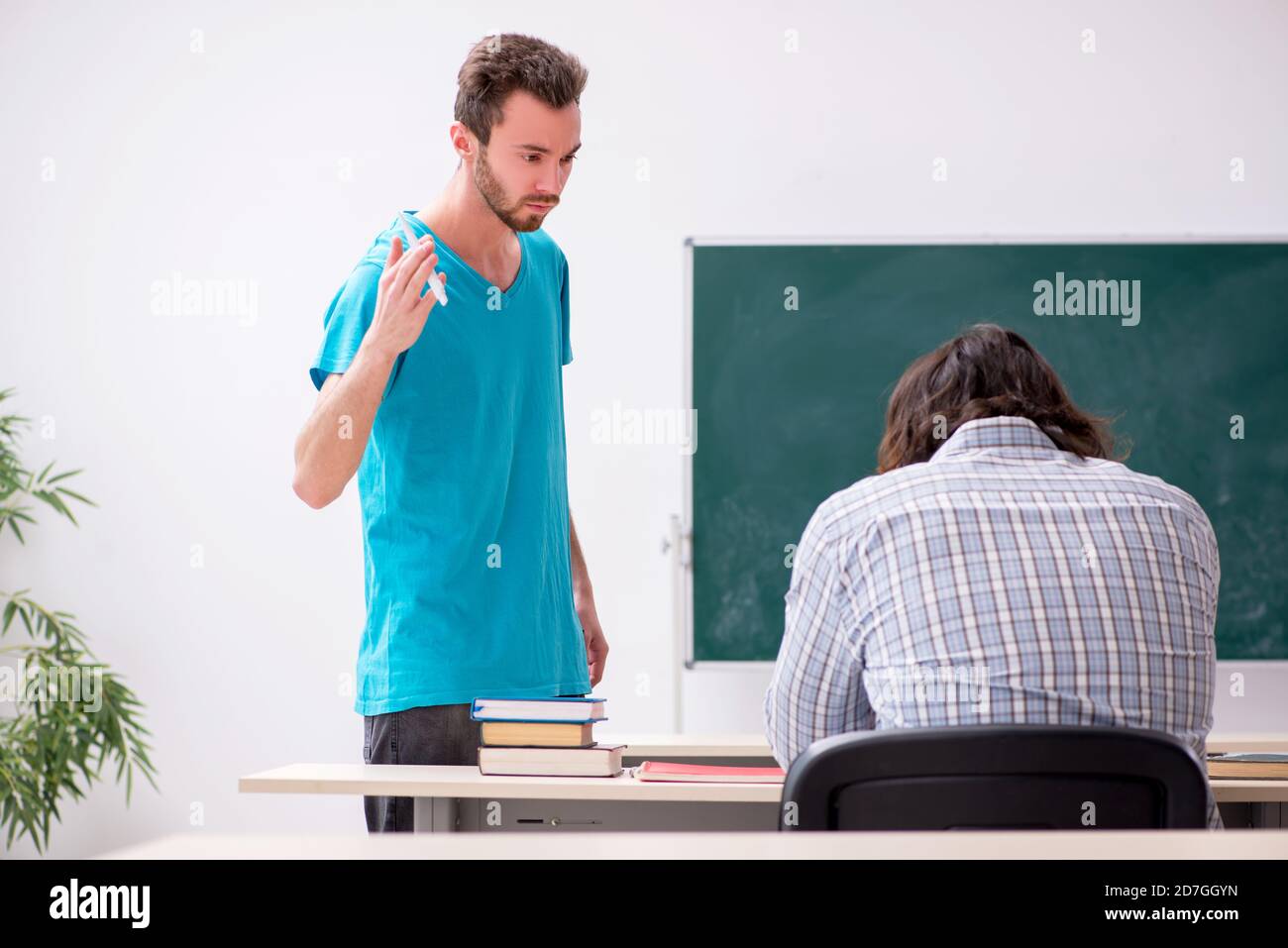 Male pupils in bullying concept in the classroom Stock Photo - Alamy