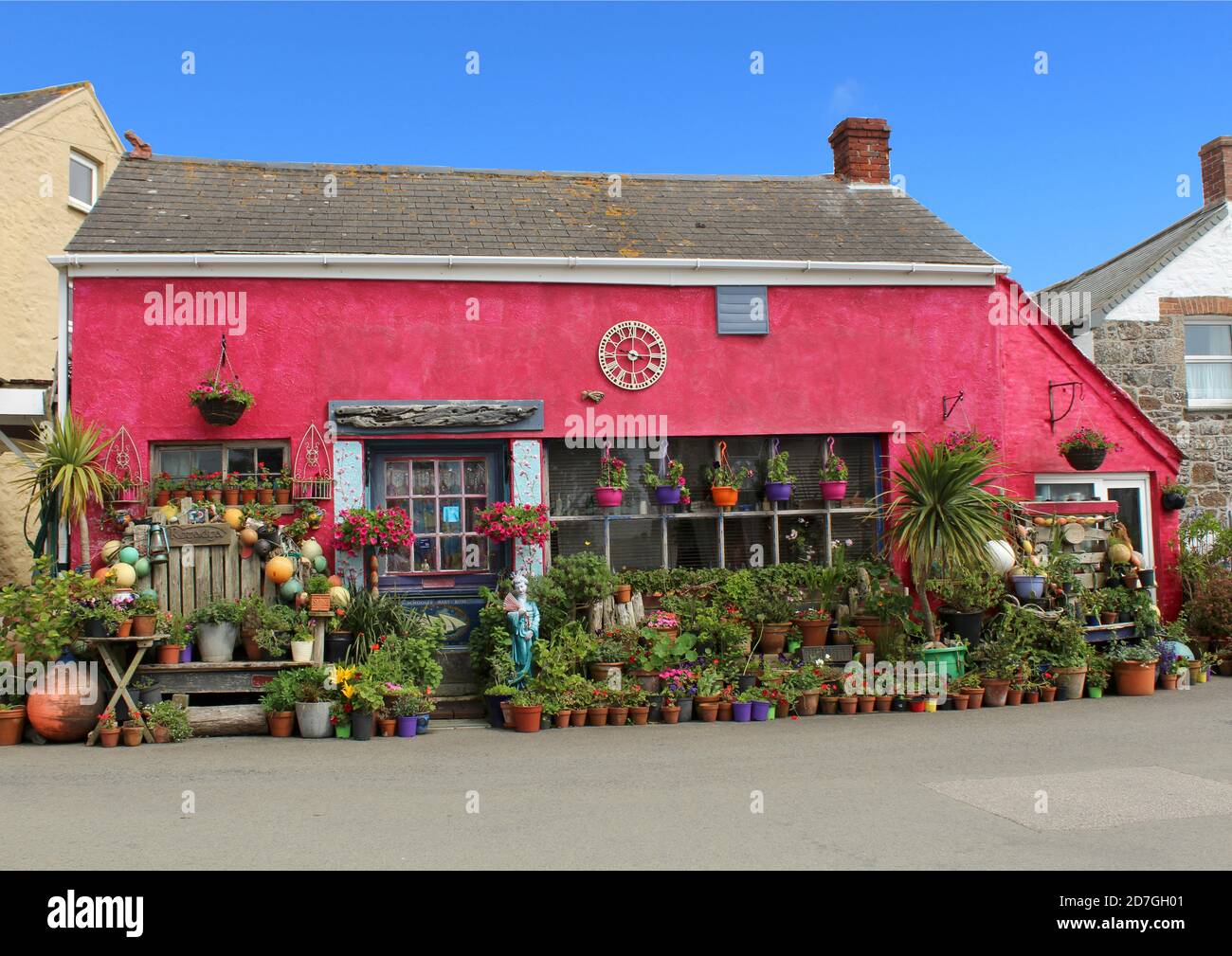 The highly colourful decoration and plants adorning a the red house in ...
