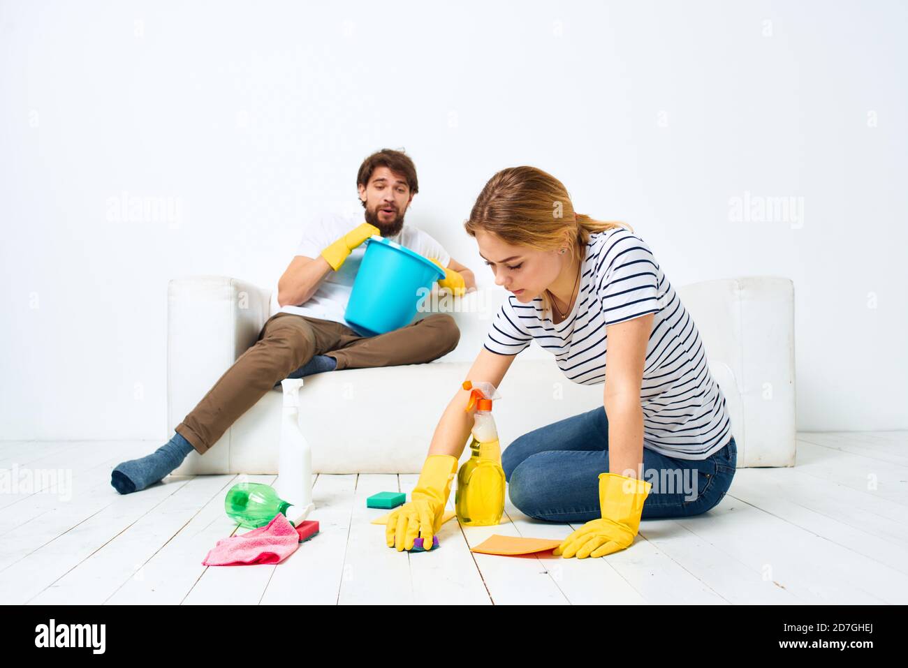 Young couple are doing cleaning together in the room light background ...