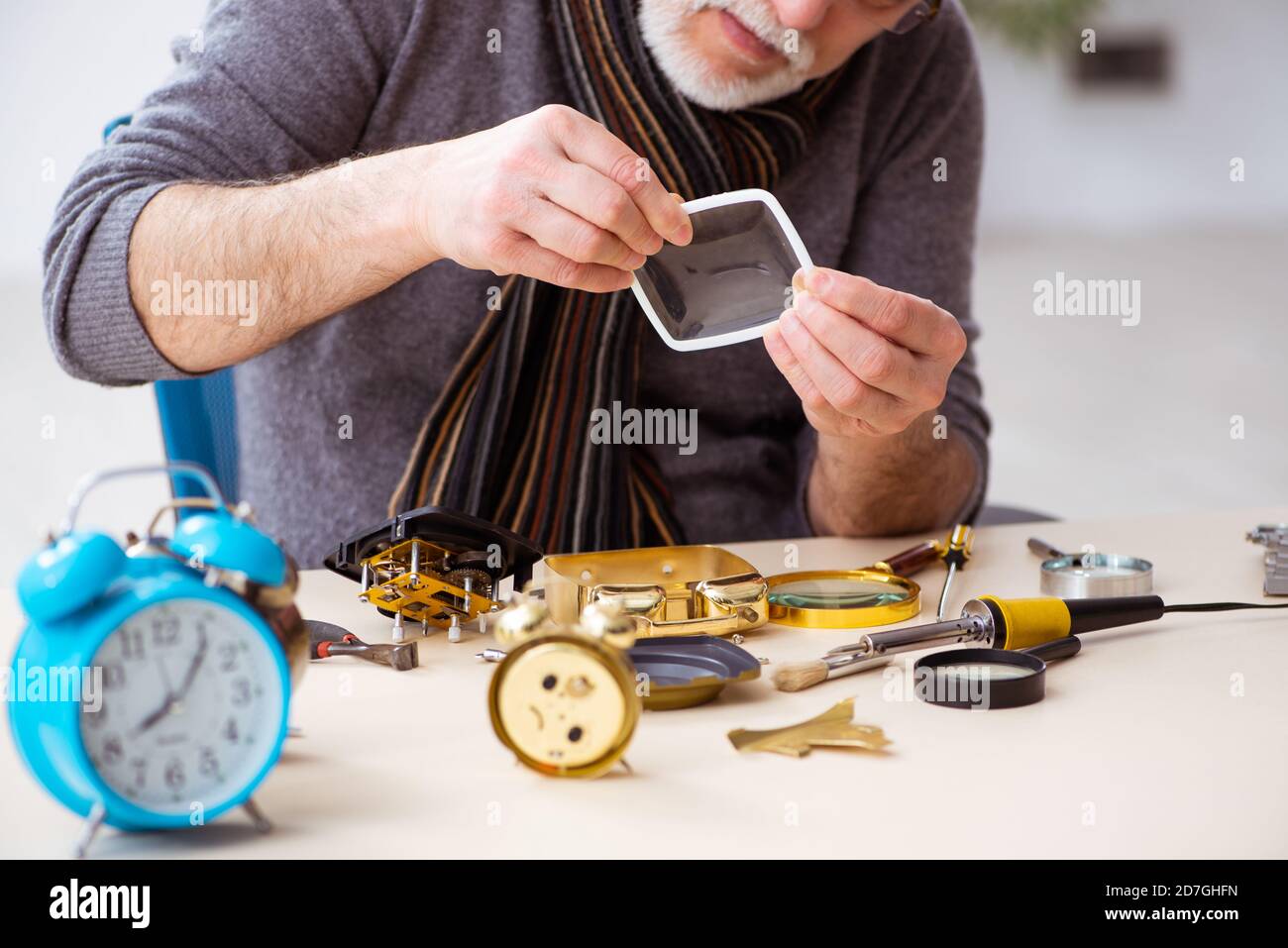 Old watchmaker working in the workshop Stock Photo - Alamy