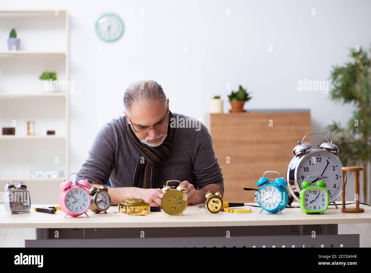 Old watchmaker working in the workshop Stock Photo - Alamy