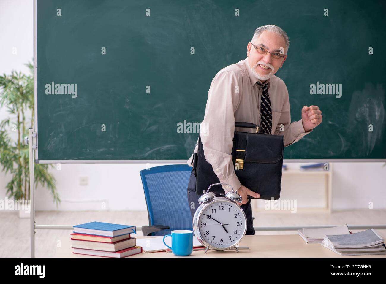Old experienced teacher in the classroom Stock Photo - Alamy