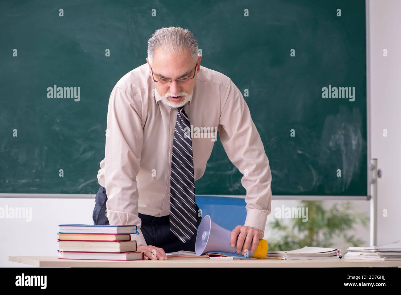 Old experienced teacher in the classroom Stock Photo - Alamy
