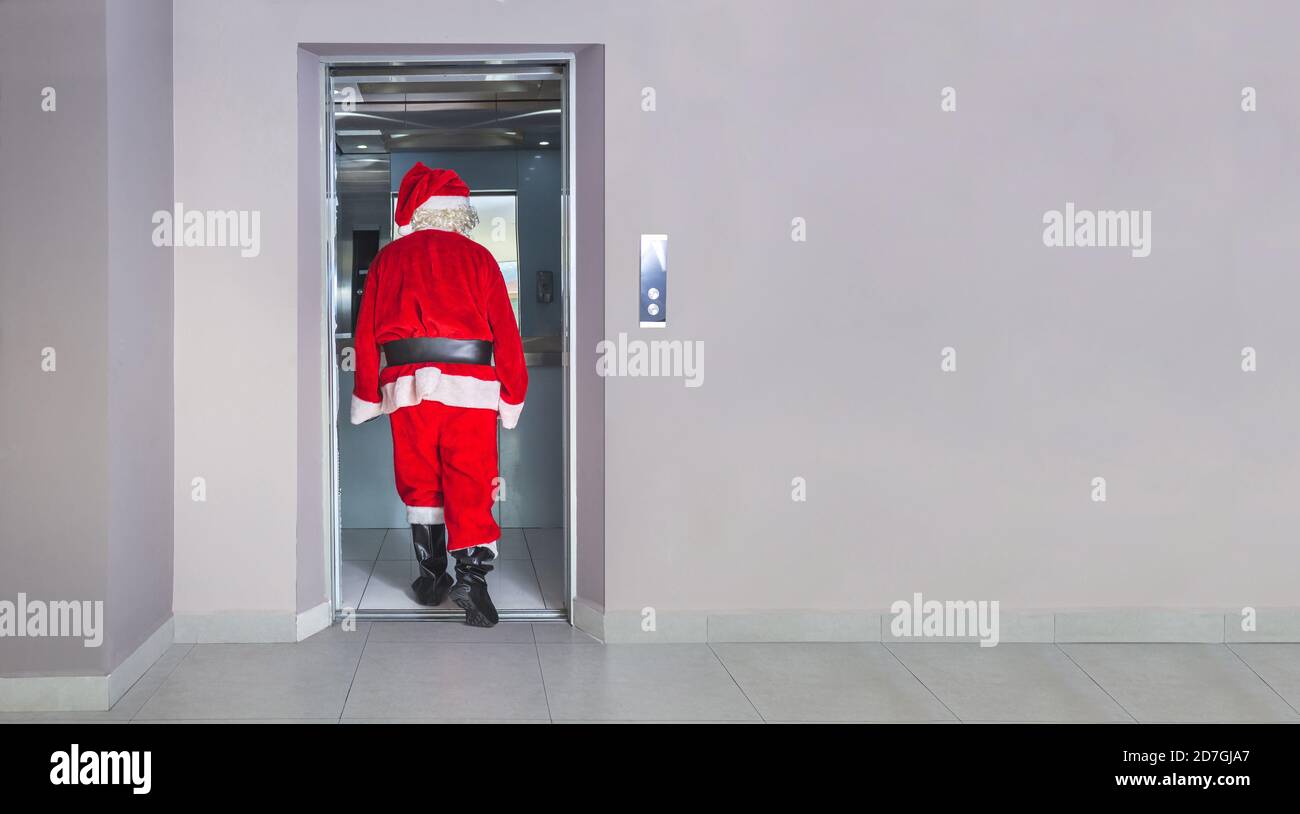 Man disguised as Santa Claus, Santa Claus entering the elevator in a ...