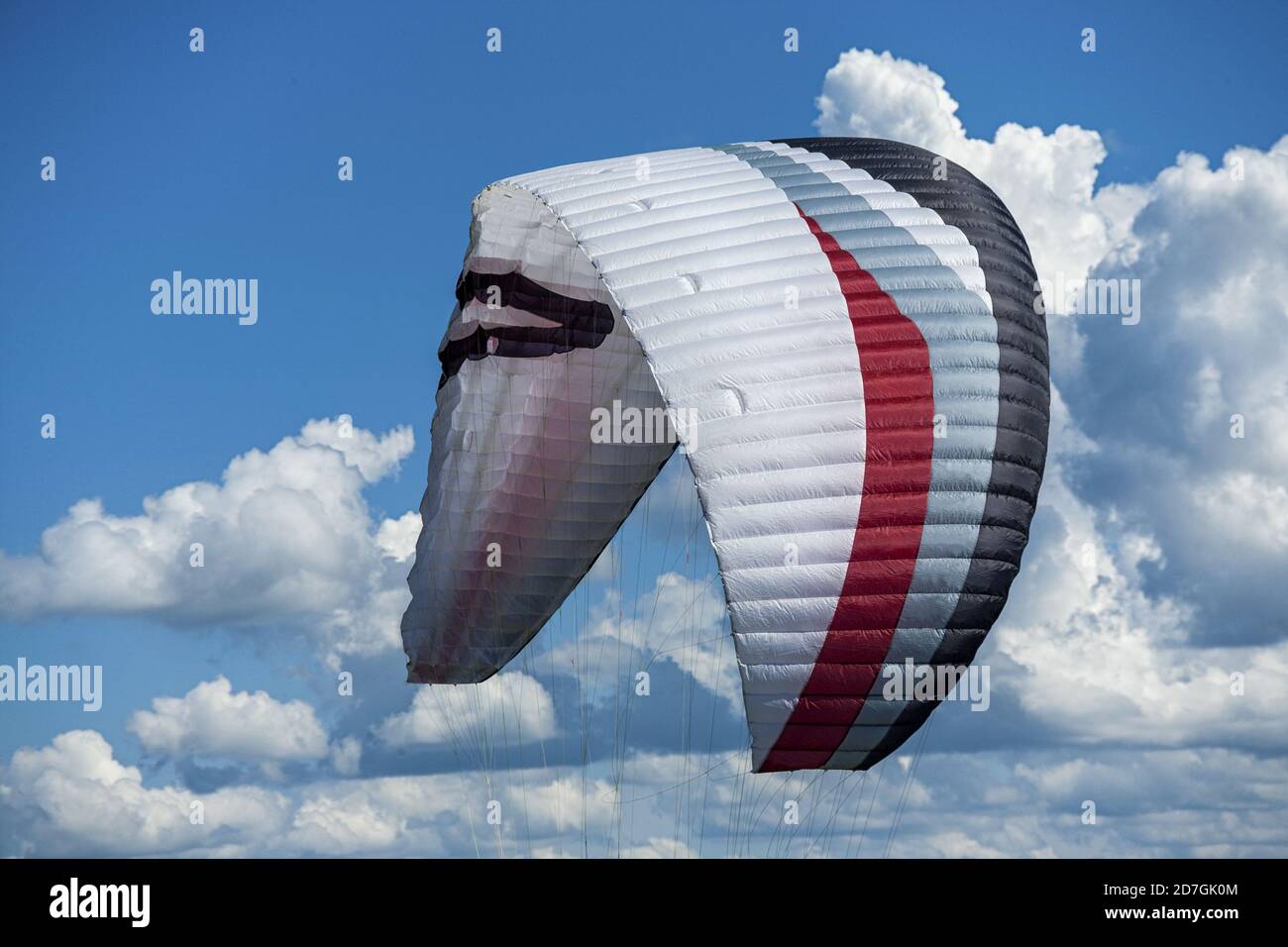 Colorful paraglider in the blue sky Stock Photo - Alamy