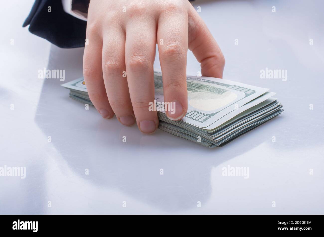 Closeup shot of a person taking dollar banknotes - concept of banking ...