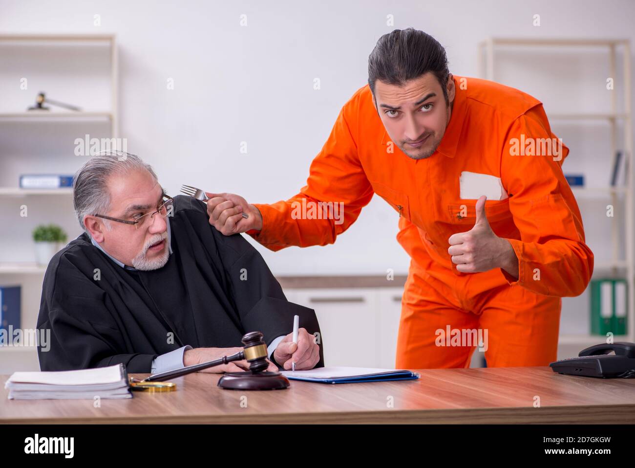Old judge meeting with young captive in courthouse Stock Photo - Alamy