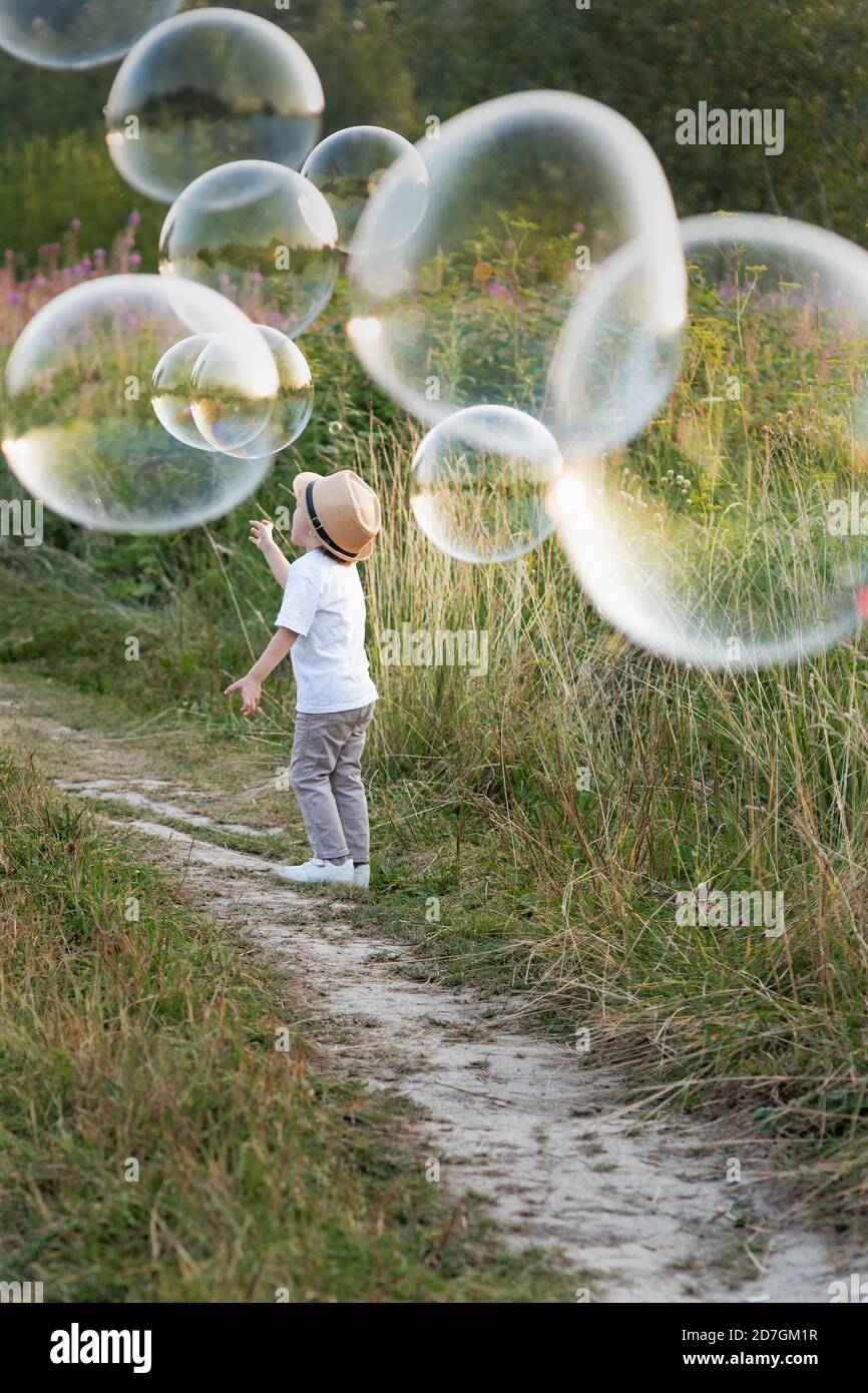 Boy catching bubbles hi-res stock photography and images - Alamy