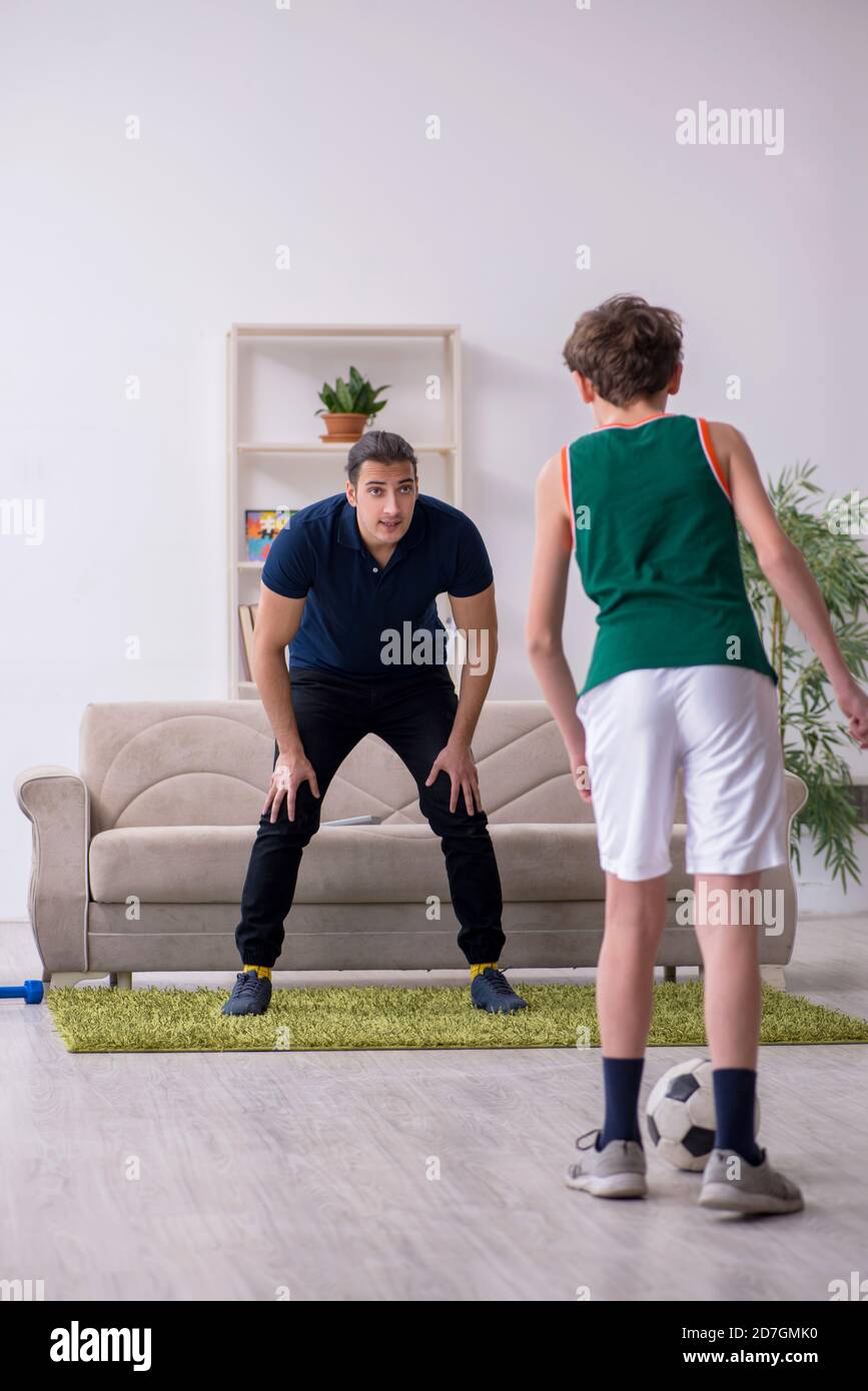 Father and son doing sport exercises at home Stock Photo - Alamy