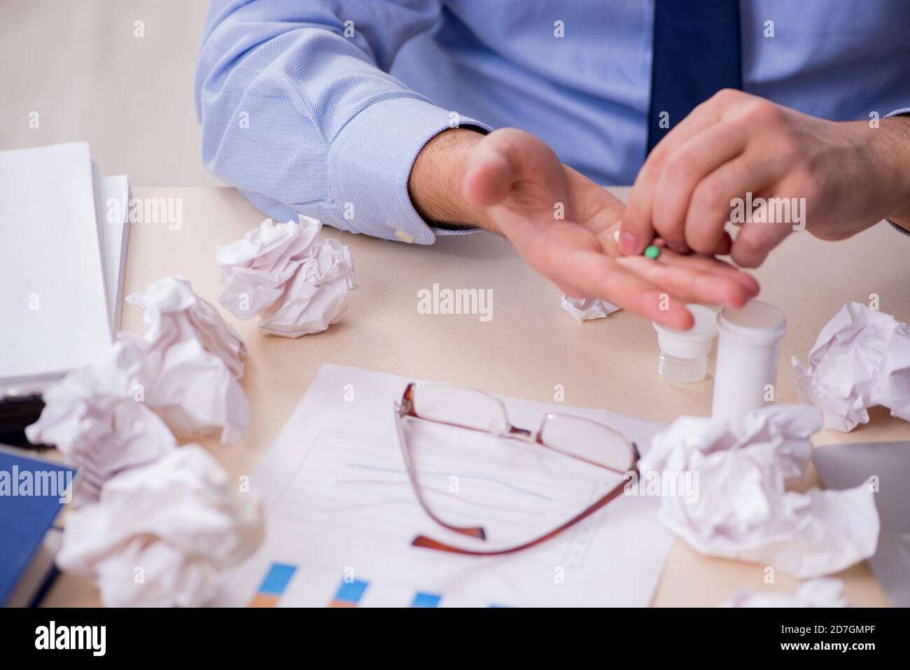 Sick male employee suffering at the workplace Stock Photo - Alamy