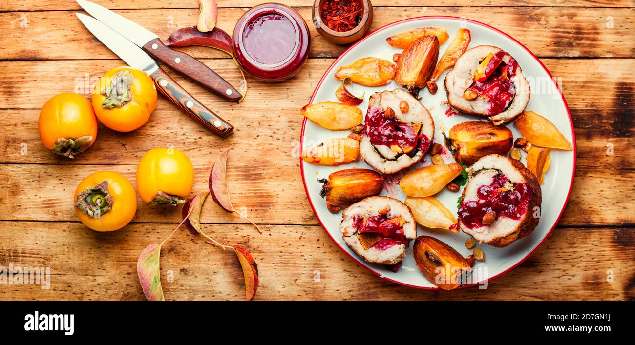 Baked pork roll with autumn persimmon.Meat stuffed with fruits Stock ...