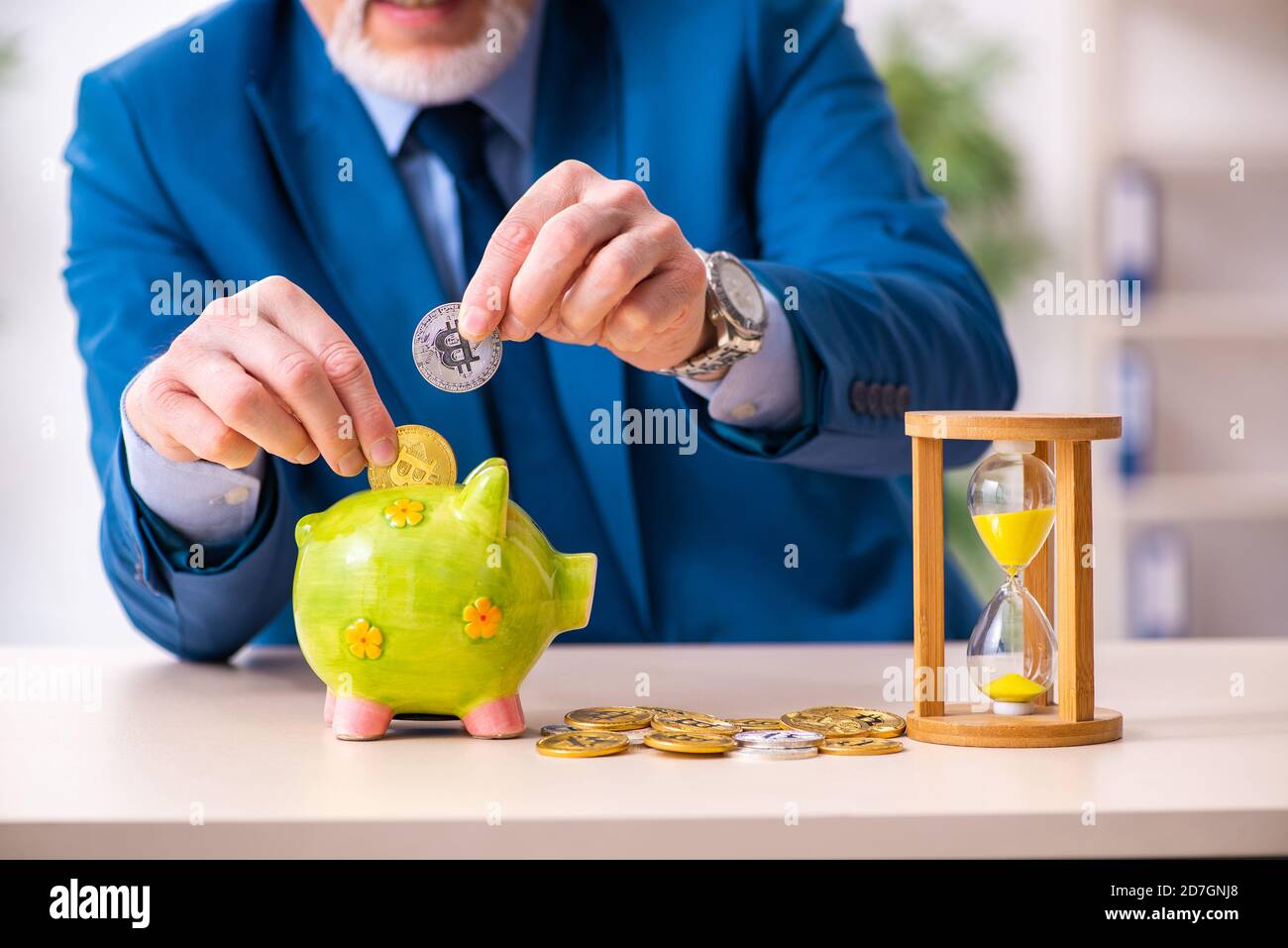 Old man earning money via internet in time management concept Stock ...
