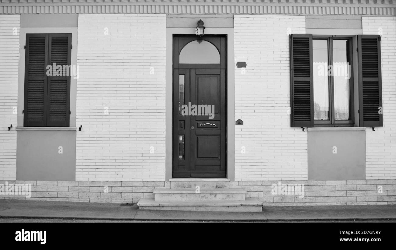 Vintage facade of an italian building with a white brick wall (Pesaro ...