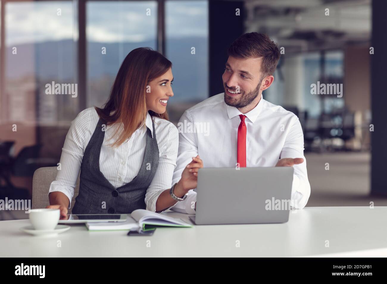Couple of busy colleagues working together in modern office Stock Photo ...