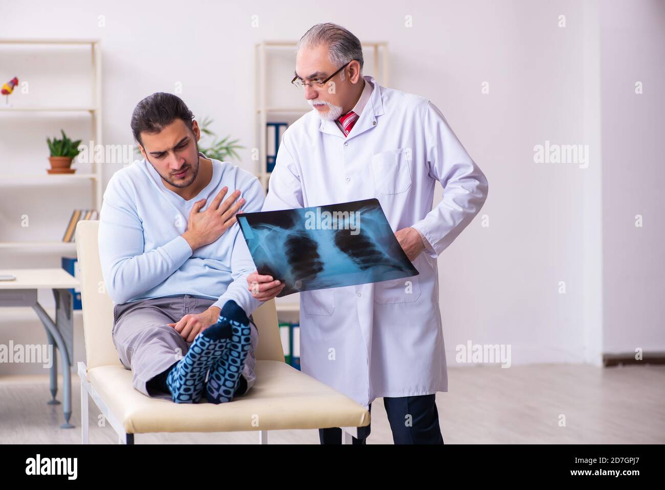 Sick man visiting old doctor radiologist Stock Photo - Alamy