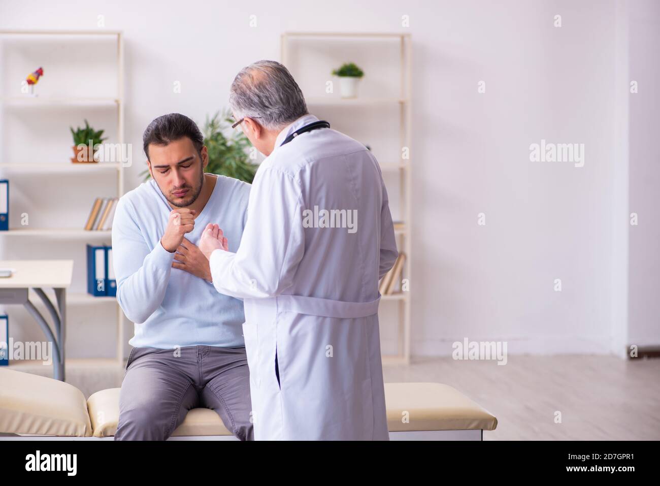 Sick man visiting old doctor Stock Photo - Alamy