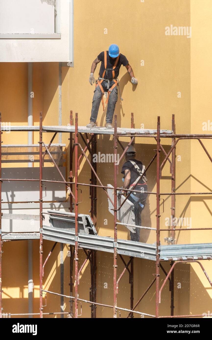 Workers at Work on a Scaffold in a Building Site for the Construction ...