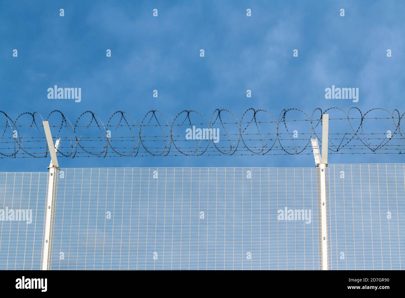 Anti intrusion barbed wire fence Stock Photo - Alamy