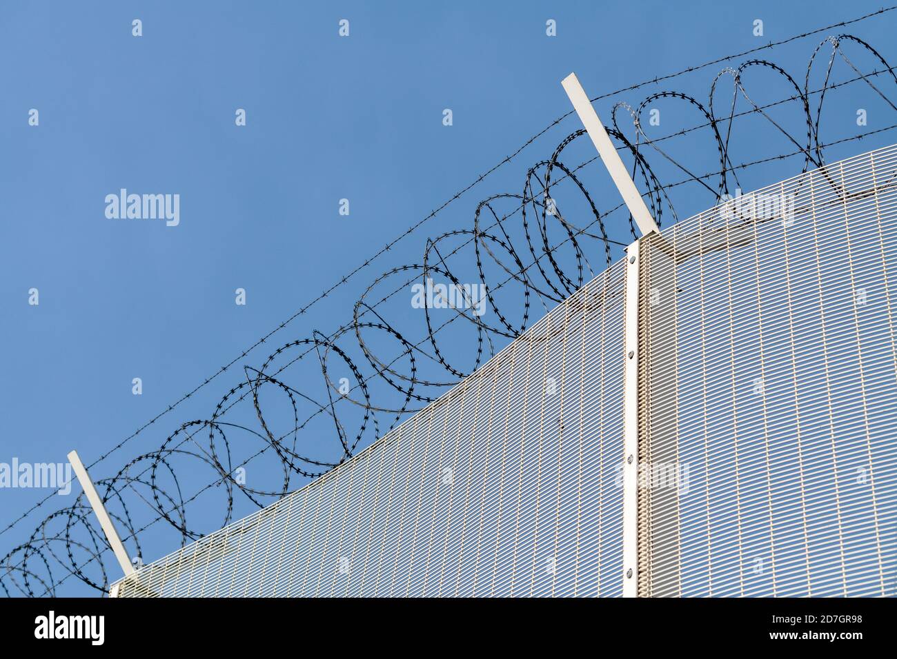 Anti intrusion barbed wire fence Stock Photo - Alamy