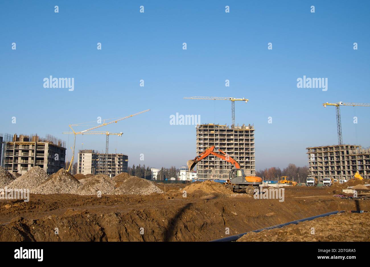 Excavator digs ground at a construction site for installing concrete ...