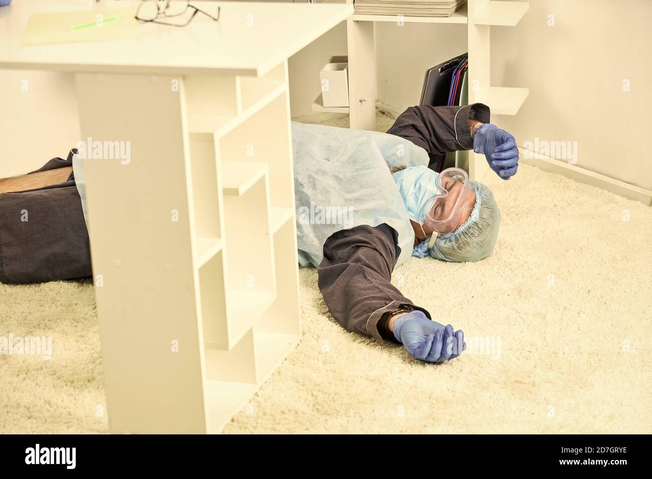 Man passed out. Shortness of breath. Man in protective equipment lay on floor. Severe condition ...