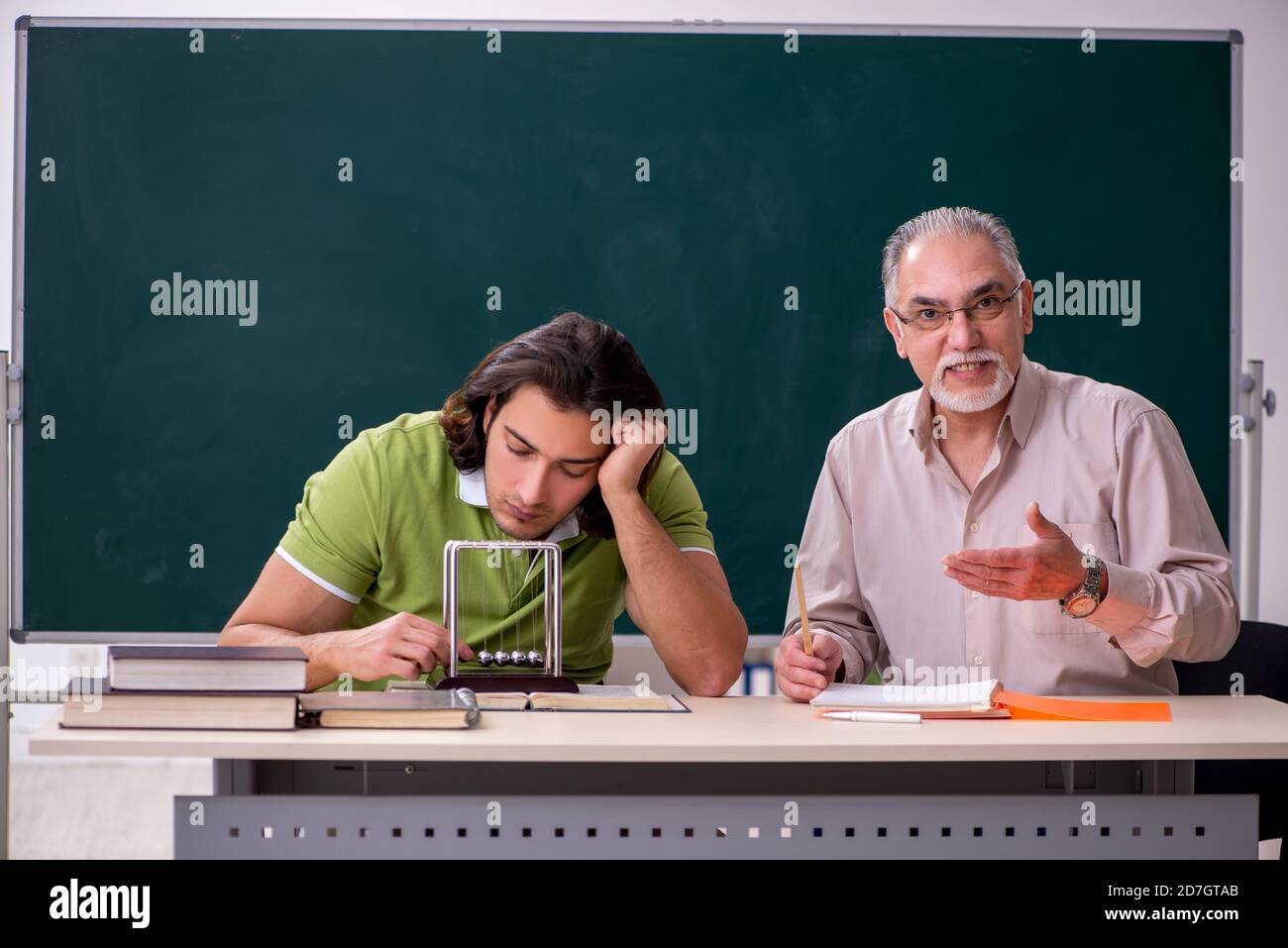 Old professor physicist and student in the classroom Stock Photo - Alamy