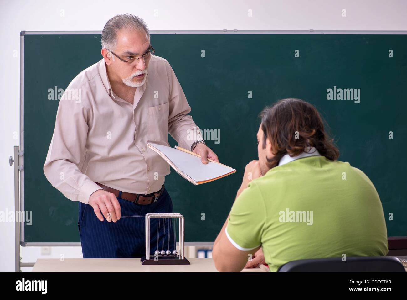 Old professor physicist and student in the classroom Stock Photo - Alamy