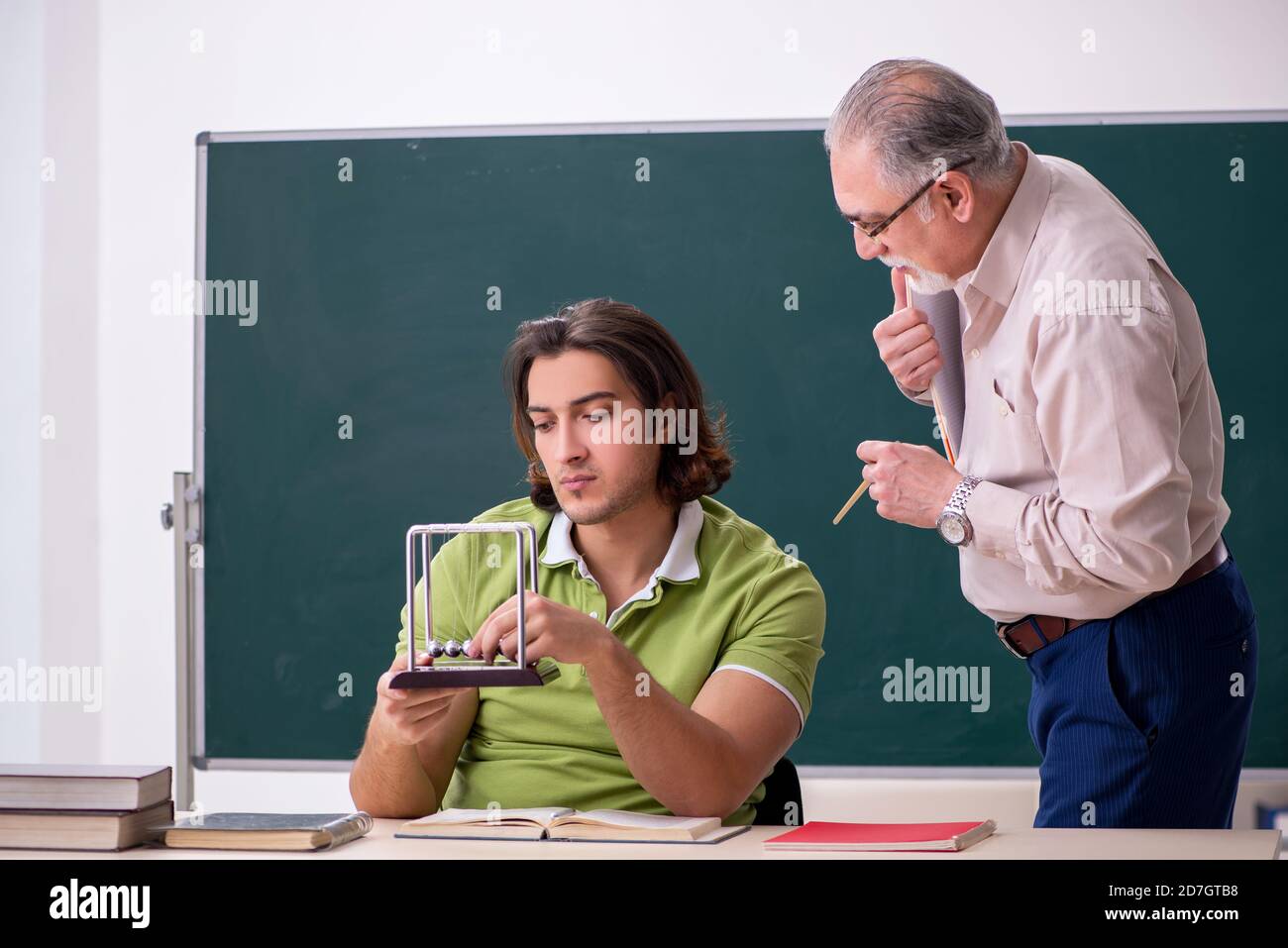 Old professor physicist and student in the classroom Stock Photo - Alamy