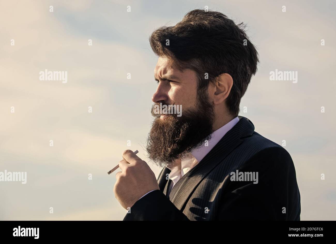 Man with beard and mustache hold cigarette. Bearded hipster smoking ...
