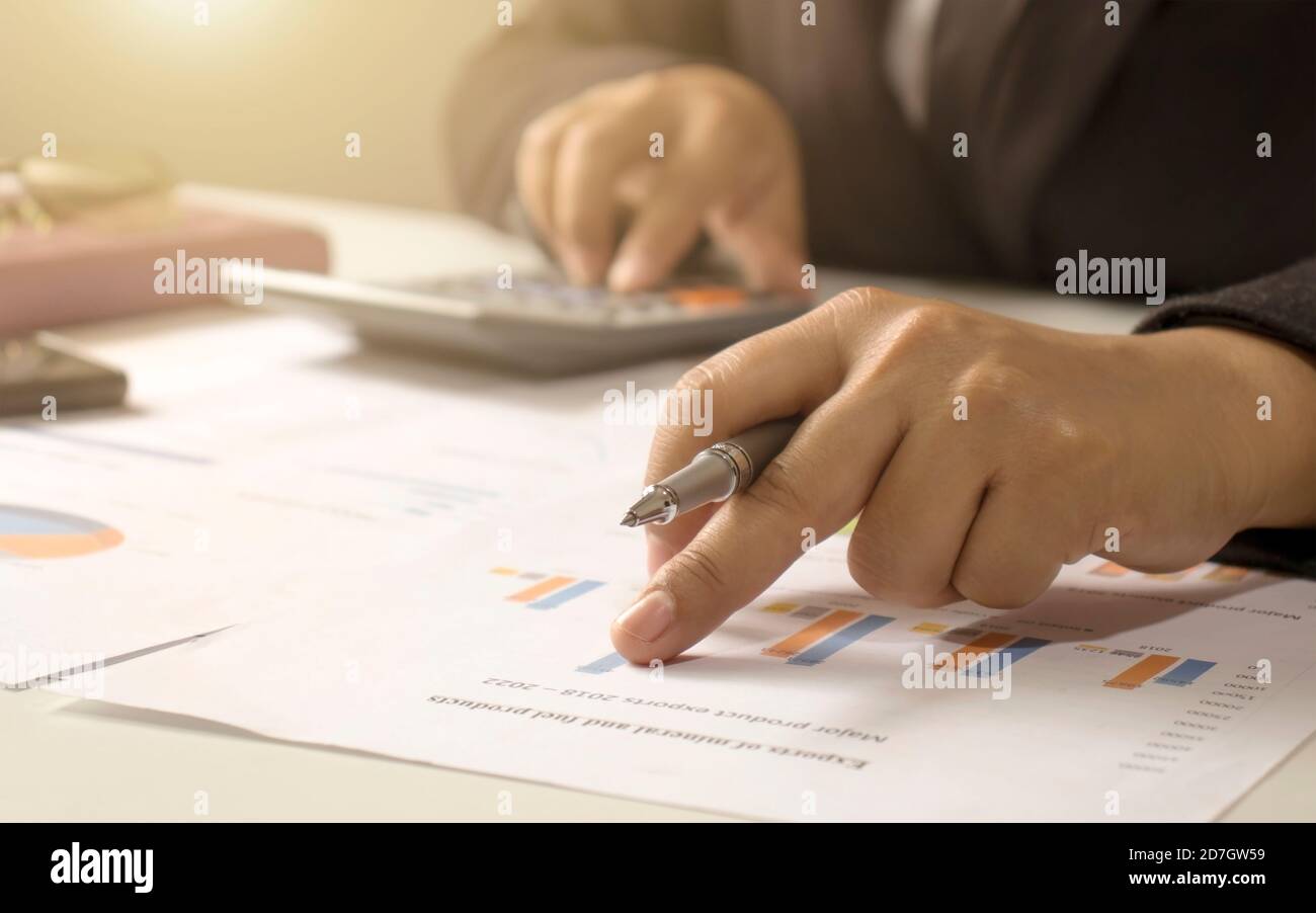 Businessmen are reviewing reports, financial documents for financial ...