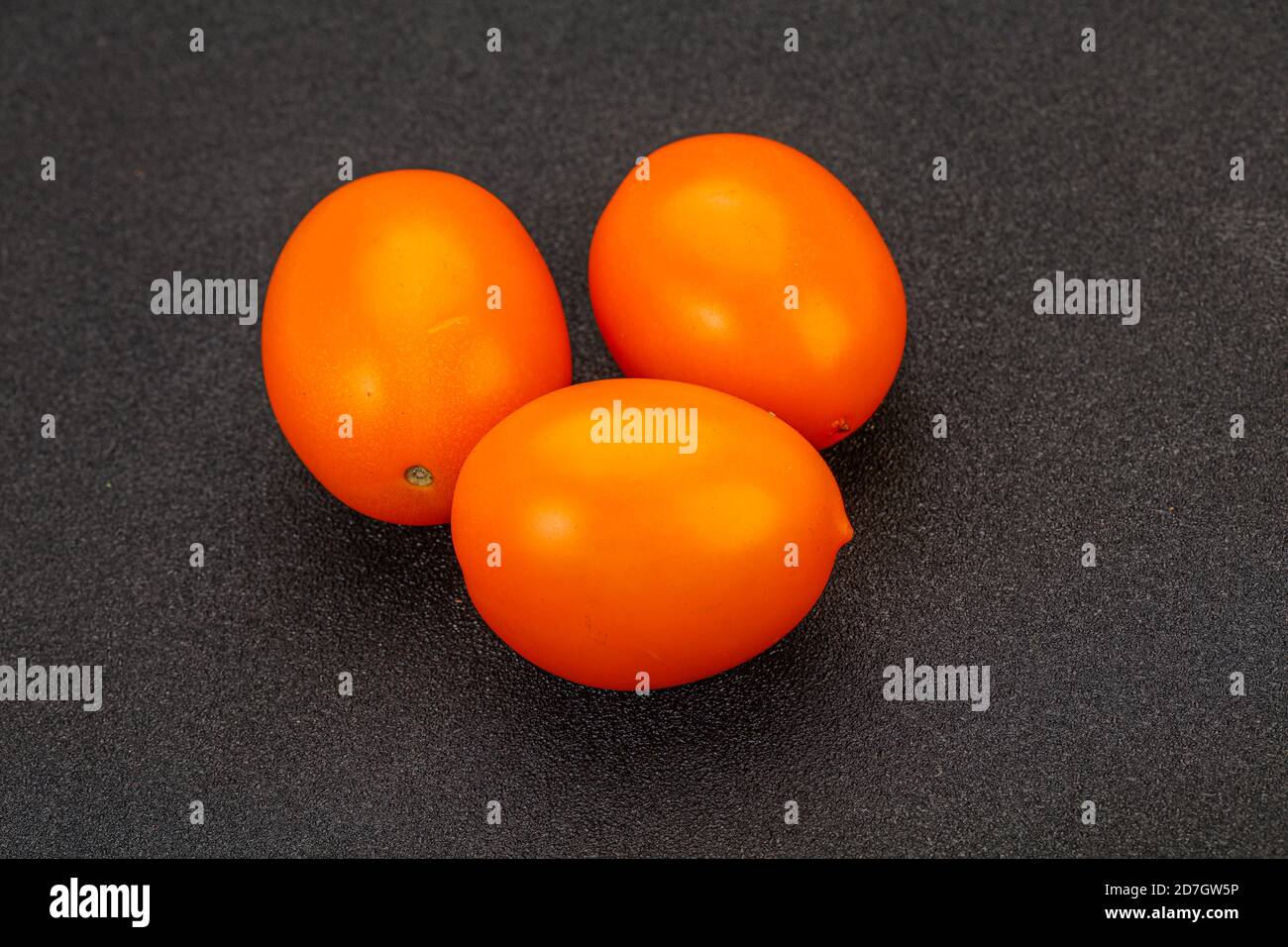 Tasty vegetables - Yellow tomato heap over background Stock Photo - Alamy