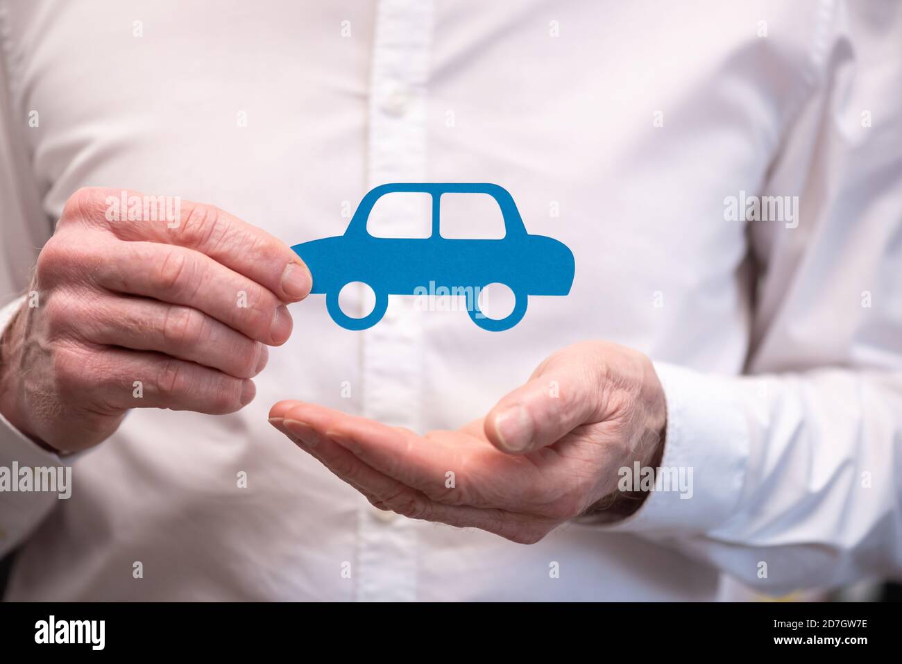 Insurer holding a paper car; Concept of car insurance Stock Photo - Alamy