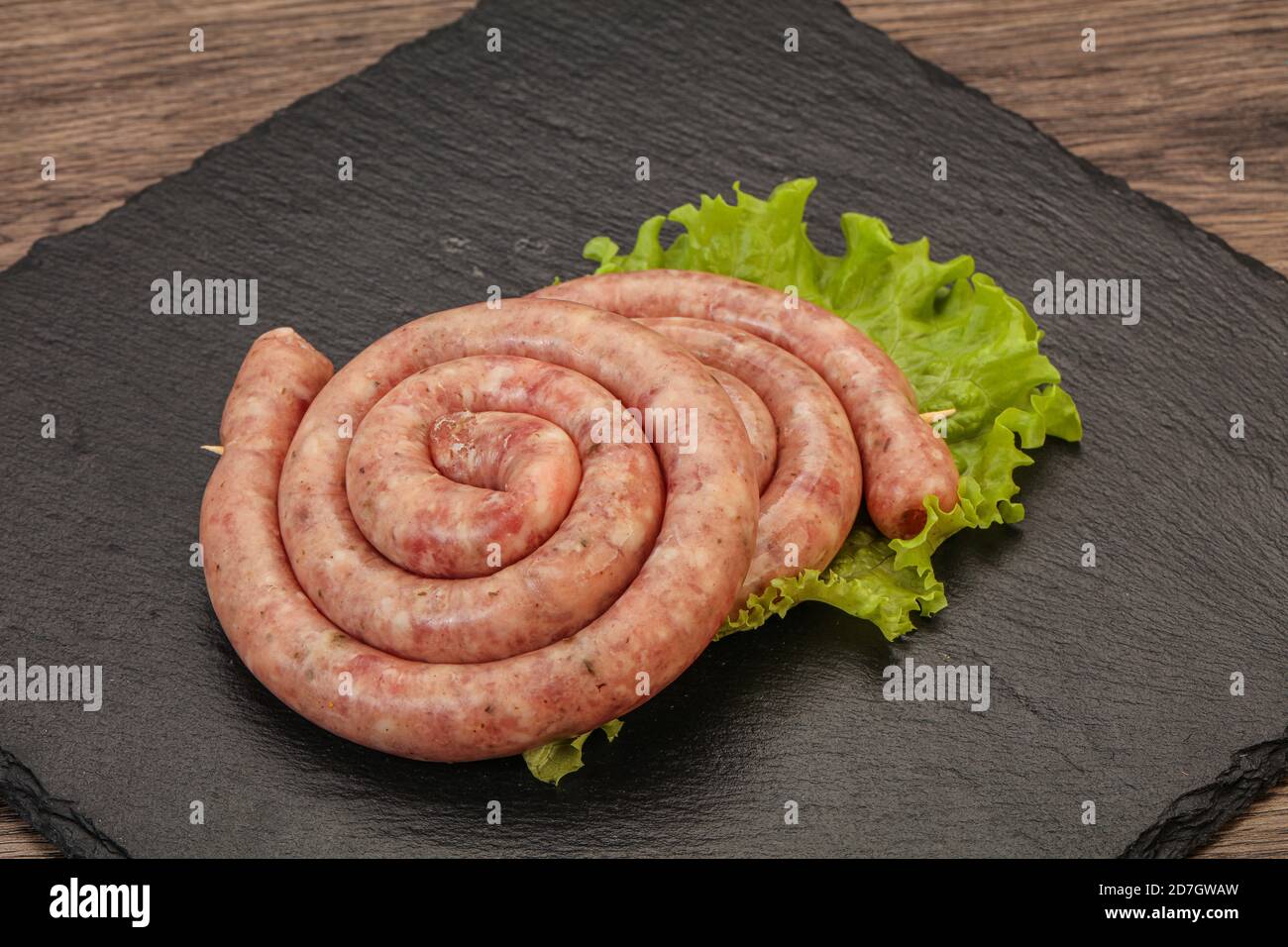 Raw pork sausage ring for grill Stock Photo - Alamy