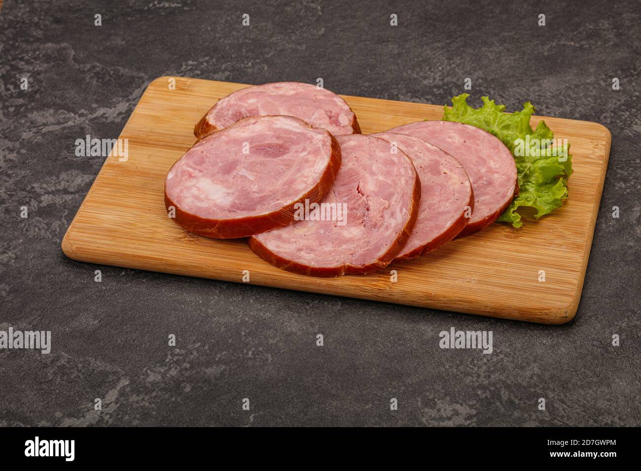 Slices of pork meat ham over wooden board Stock Photo - Alamy