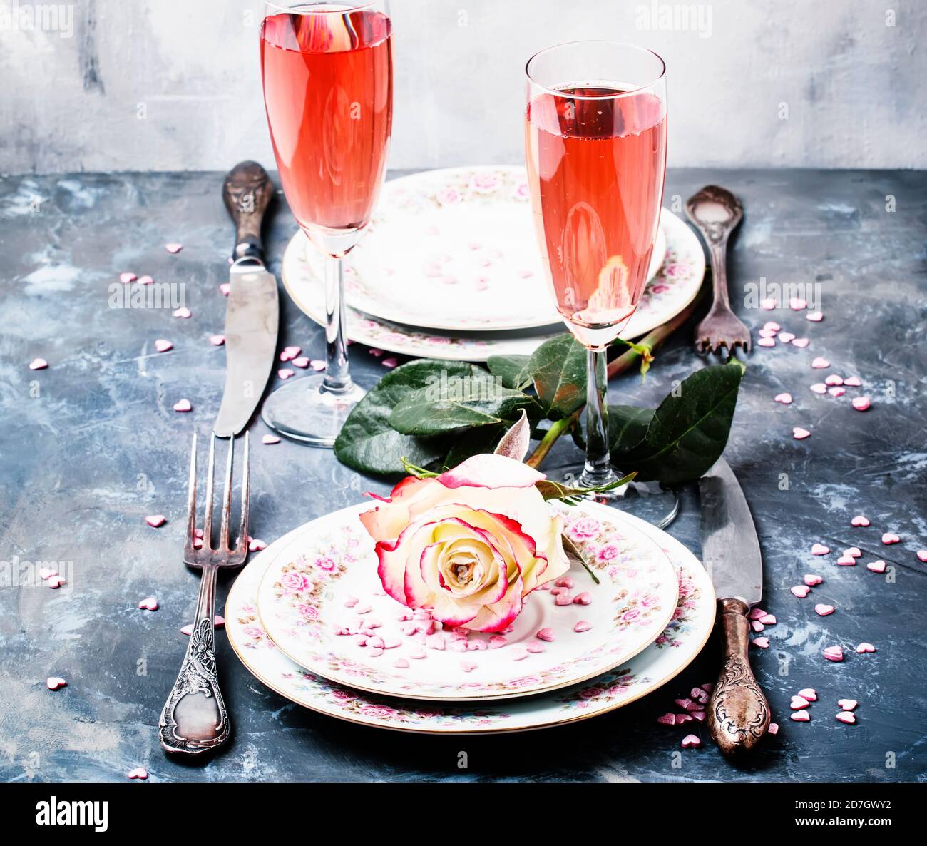 Festive table setting for valentines day, plates and glasses with pink ...