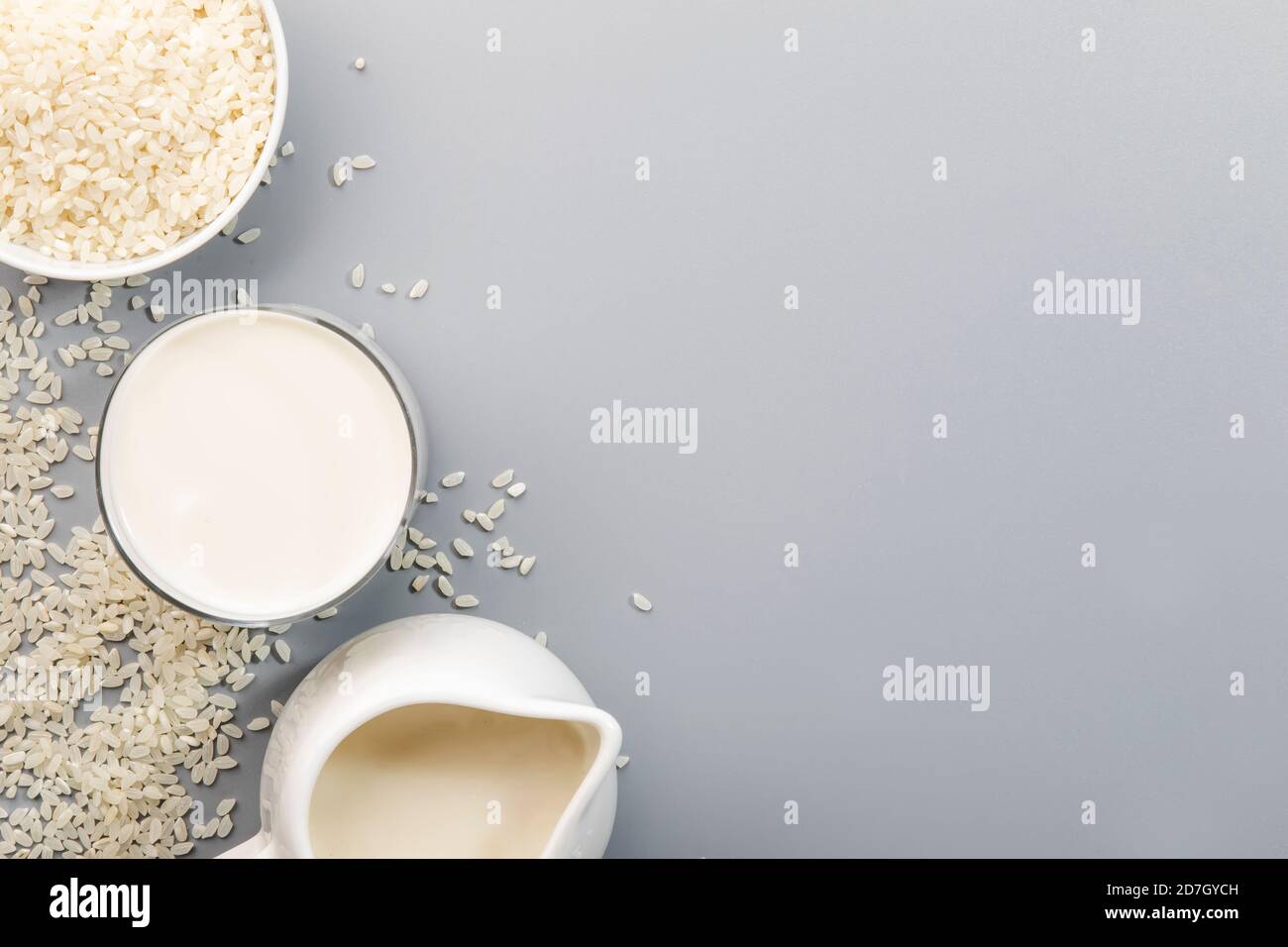 Vegan Rice milk with rice grains on gray background. Copy space, top ...