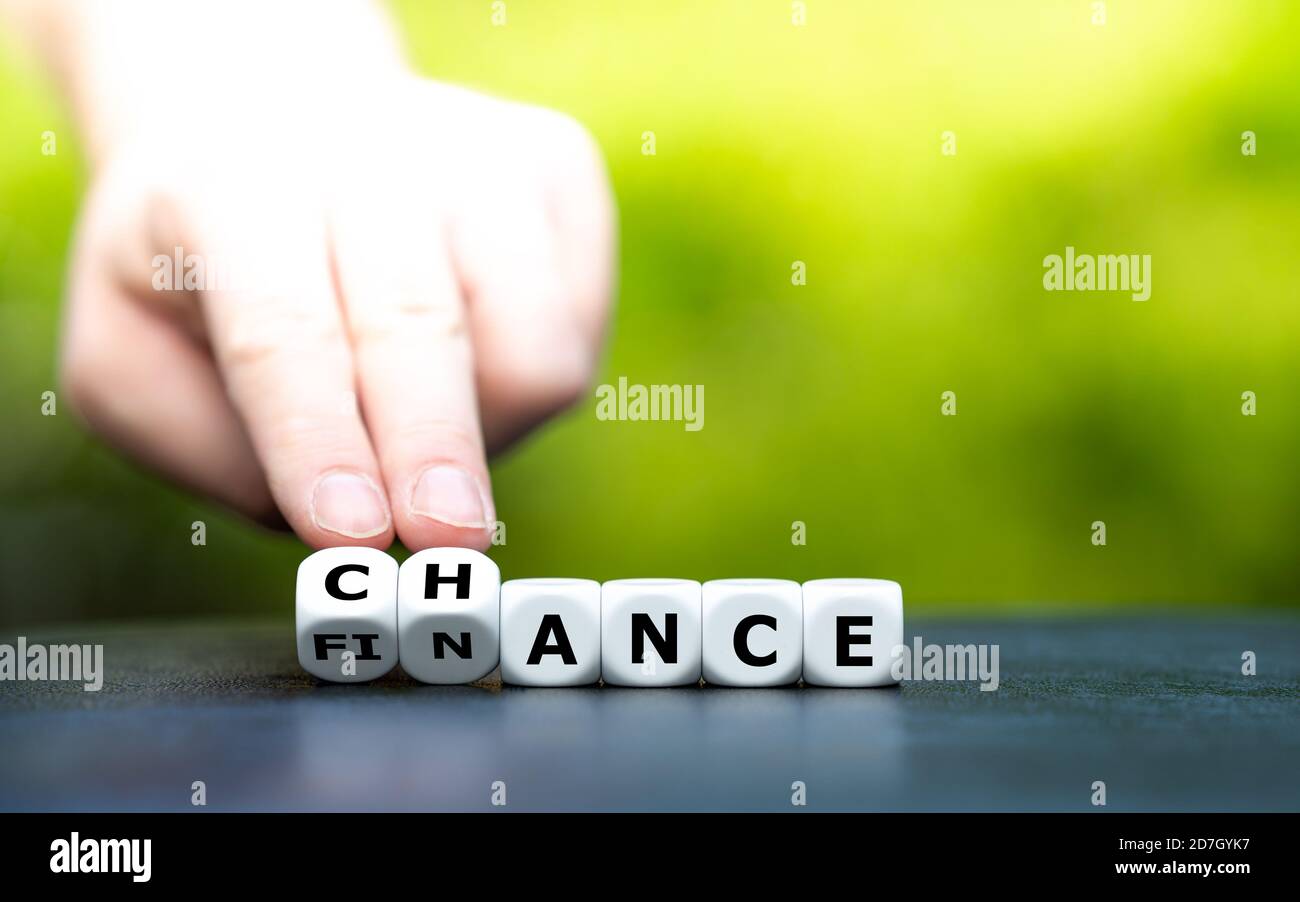 Symbol for a financial chance. Hand turns dice and changes the word ...