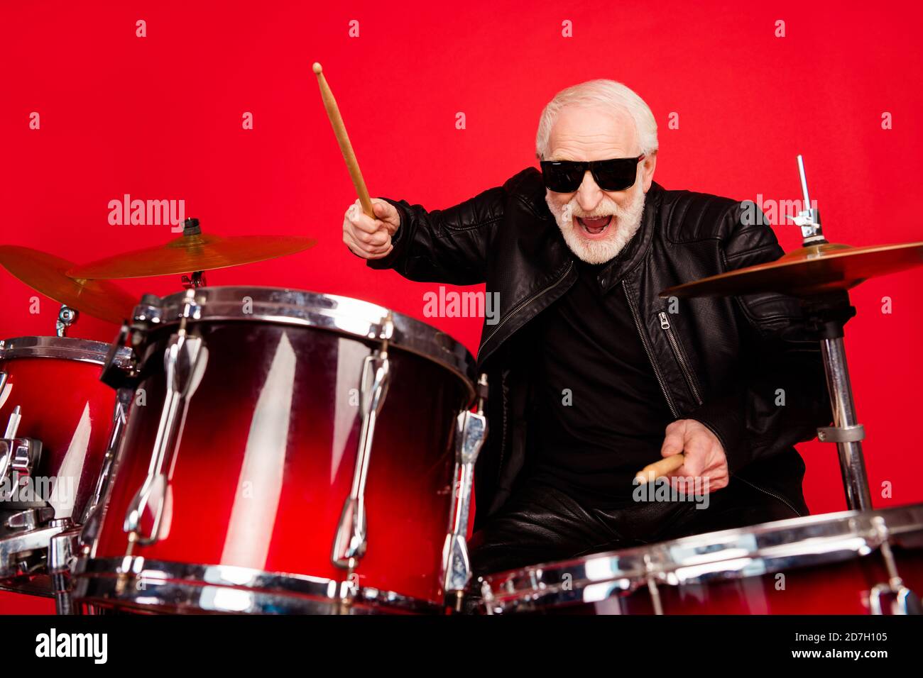 Portrait of crazy funky old man punk rocker play drum enjoy night club ...