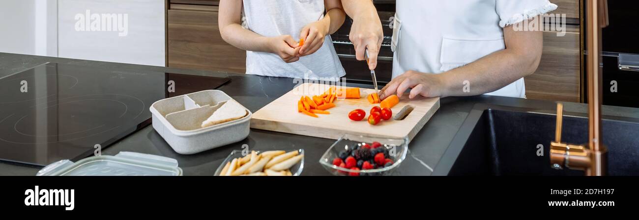 Mother preparing healthy snack for her daughter for school Stock Photo ...