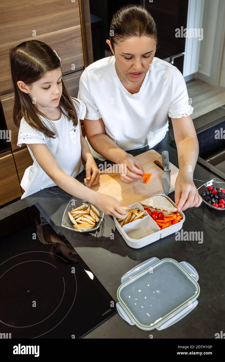 Mother and daughter preparing the lunch box for school Stock Photo - Alamy