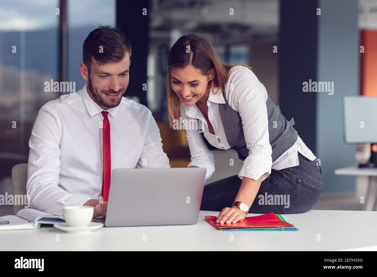 Couple of busy colleagues working together in modern office Stock Photo ...