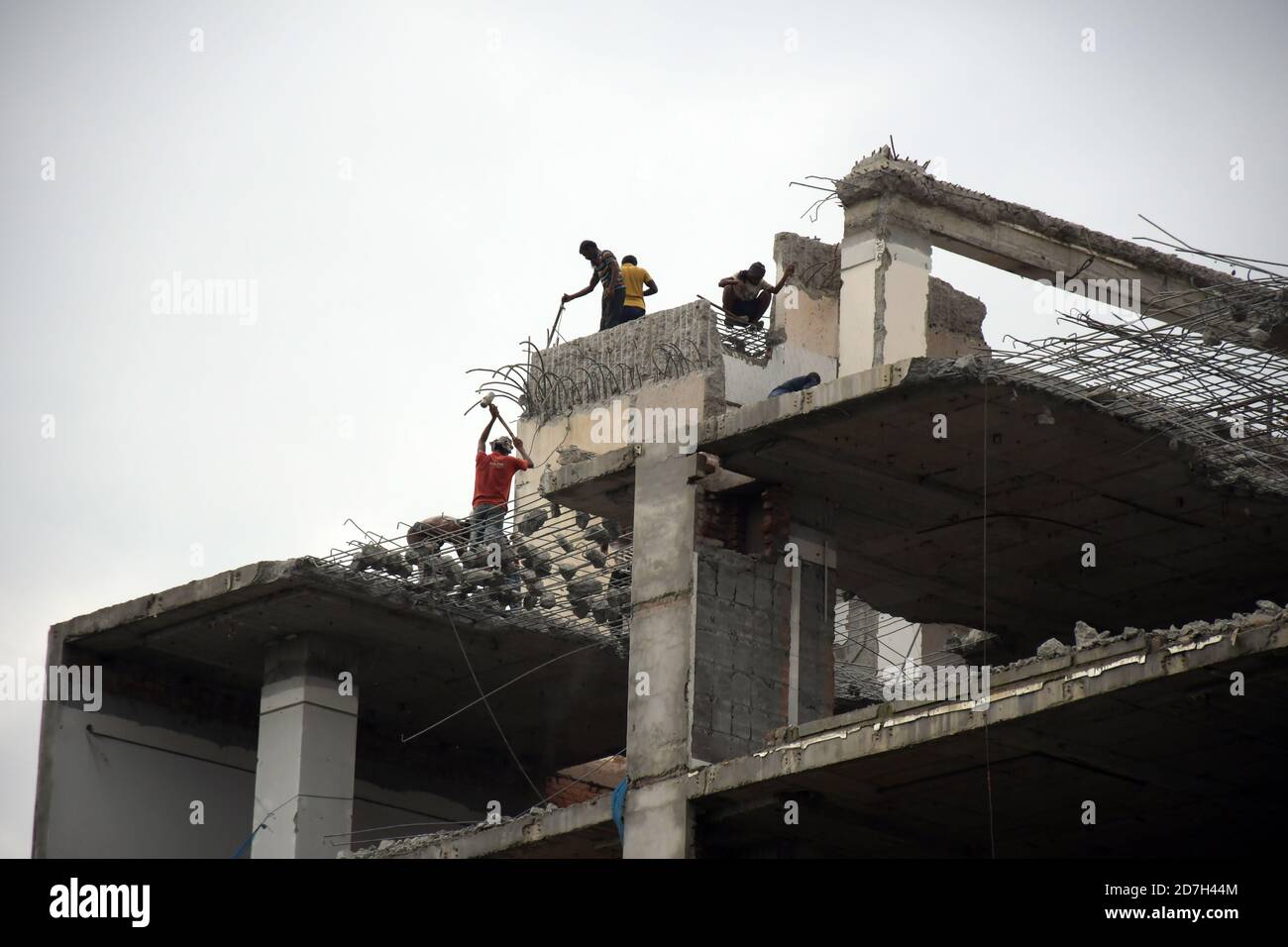 DHAKA, BANGLADESH– 21 October 2020: Bangladeshi worker uses a sledge ...