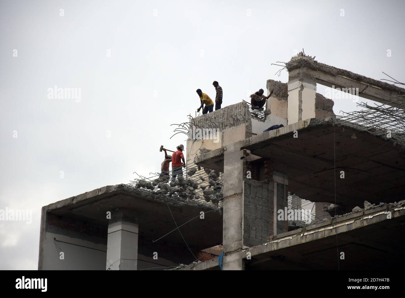 DHAKA, BANGLADESH– 21 October 2020: Bangladeshi worker uses a sledge ...